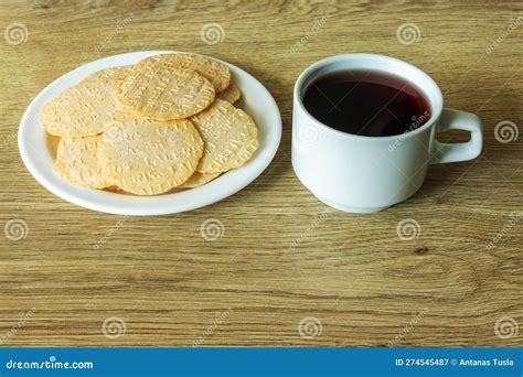 chips with the lithuanian text taler and tea on the table stock image