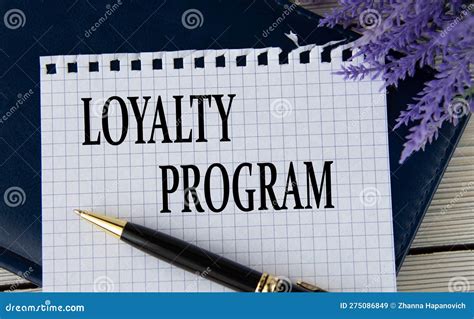 loyalty program words on a white sheet with a black notepad and pen