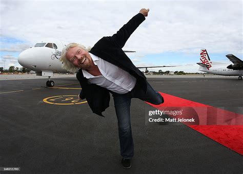 Sir Richard Branson Poses In Front Of An Aircraft At Perth Airport On
