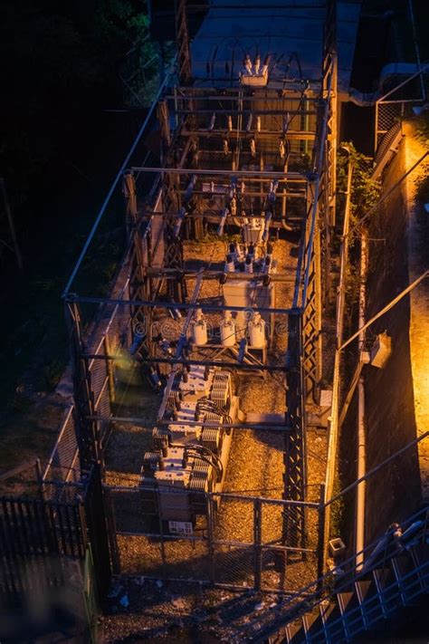 Industrial Electric Substation Illuminated At Night Under Artificial