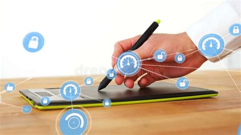 Animation Of Connected Icons Over Cropped Hand Of Caucasian Man Drawing On Graphics Tablet Stock