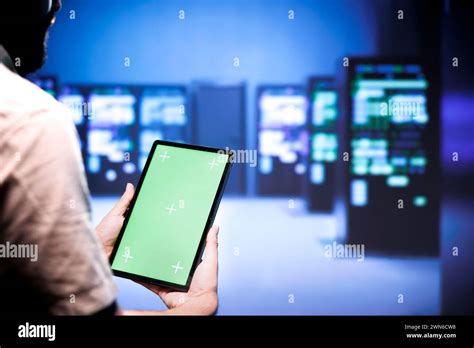computer scientist using green screen device to verify data center