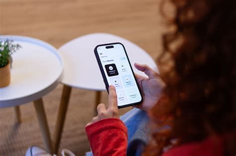 홈 오토메이션 시스템을 제어하기 위해 휴대 전화에서 스마트 홈 앱을 사용하는 여성 20 29세에 대한 스톡 사진 및 기타 이미지 20 29세 Brand Name