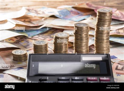Calculator With Coin Stacked And Currency Notes Stock Photo Alamy
