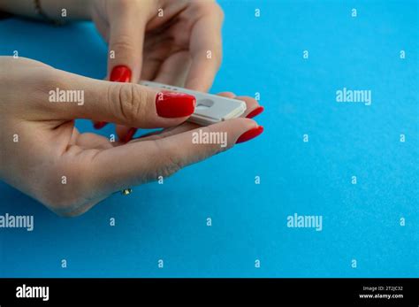 Disposable Pregnancy Test Strip Girl With Red Manicure Makes A Test To Determine Pregnancy