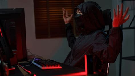 premium photo hacker in hoodie raising hands while having problem