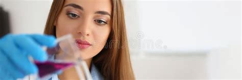 Female Scientist Pour Pink Liquid From Flask In Medical Chemistry Lab Stock Photo Image Of