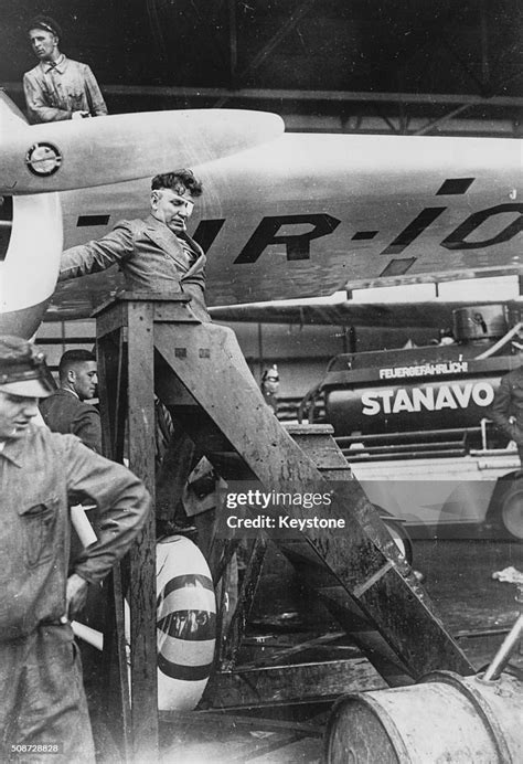 American Aviator Wiley Post Wearing An Eye Patch Climbing Out Of An