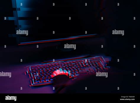 hacker in the hood working with computer typing text in dark room