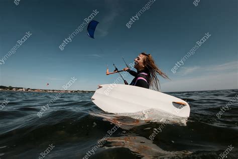 Extremal Girl With A Surfboard With A Parachute In The Sea 이미지