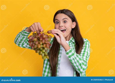 Muchacha Sorprendida Con Uvas De Fondo Amarillo Imagen De Archivo Imagen De Fruta Uvas 256935463