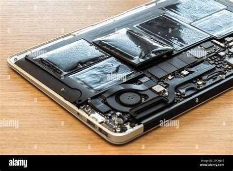 Swollen Battery Of Broken Laptop In Open Casing Closeup Heavy Damage Of Notebook Computer