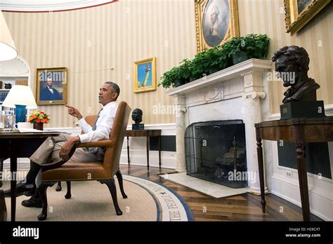 Us President Barack Obama Sits At His Desk During A Meeting In The White House Oval Office