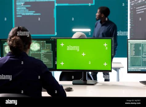 Hackers Team Working With A Green Screen Layout On Computer In