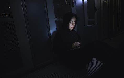 Premium Photo Hacking Laptop And Hacker Woman In Dark Server Room For