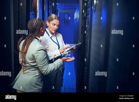 They Hold The Technical Expertise To Solve Any Errors Two Technicians Using A Digital Tablet