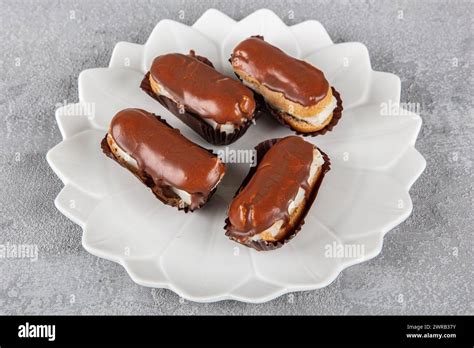 Eclairs With Chocolate Topping On Serving Plate Traditional French Eclairs With Chocolate Mini