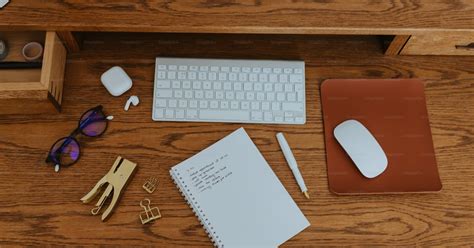 A Desk With A Keyboard Mouse Glasses And A Notepad Photo Desktop Image On Unsplash