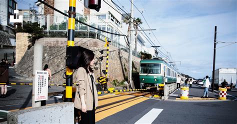 낮에는 하얗고 푸른 하늘 아래 도로를 보는 기차와 건물 근처에 서 있는 여자 사진 Unsplash의 무료 아스팔트 이미지