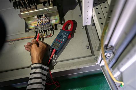 전기 및 전기 유지 보수 서비스 엔지니어 손 회로 차단기 단자 및 케이블 배선 주 배전 보드에서 전류 전압을 확인하는 Ac 멀티