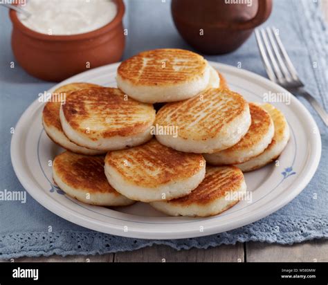 Syrniki The Traditional Russian Cheese Pancakes On A Rustic Table