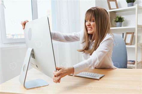Angry Evil Blonde Businesswoman Screaming To Desktop Raging After