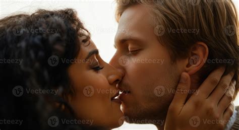 Romantic Interracial Couple Sharing Intimate Kiss At Sunset For Love
