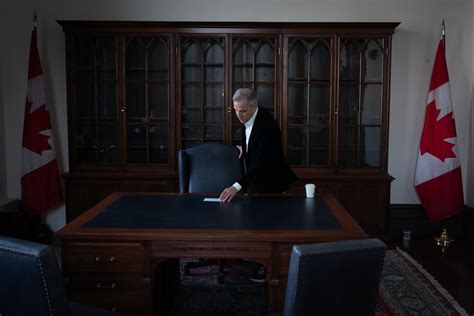 Prime Minister Mark Carney reads a note left behind on his desk from former prime minister ...