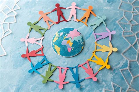 Colorful Paper Cutout Figures Holding Hands Around The Globe Symbolizing Unity Diversity And