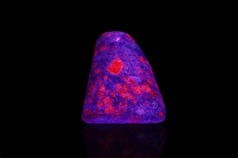 Premium Photo Macro Mineral Stone Ruby Under Ultraviolet Light On A Black Background