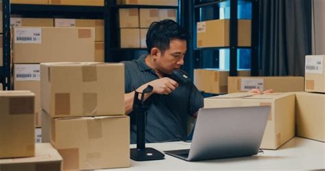 Premium Photo Asian Man Use Barcode Scan Data In Box And Type Register Online Order In Laptop