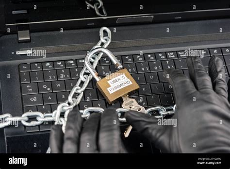 Hands With Gloves Typing On Laptop Keyboard With Padlock Cyberattack