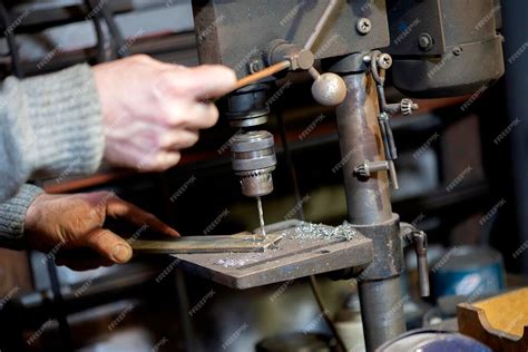 Premium Photo Blacksmith Uses Drill Press In Garage A Close Up View