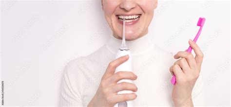 Cropped Smiling With Ideal Teeth Woman Holds Oral Irrigator Toothbrush