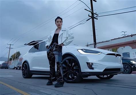 A Scene Showing A Woman Standing Next To A Tesla Model X Premium Ai