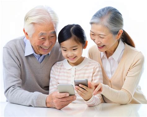 A Girl Helping An Aged Couple Learn How To Use A Smartphone Premium