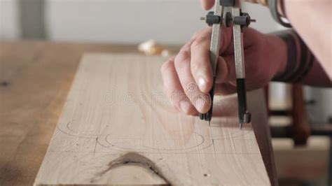 A Carpenter Marks A Pine Wooden Plank With A Compass Woodworker Using A Compass On A Piece Of