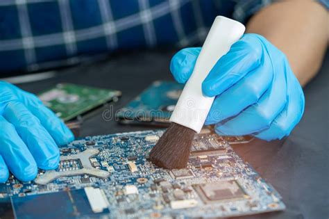 Asian Technician Repair And Cleaning Dirty Micro Circuit Main Board Of