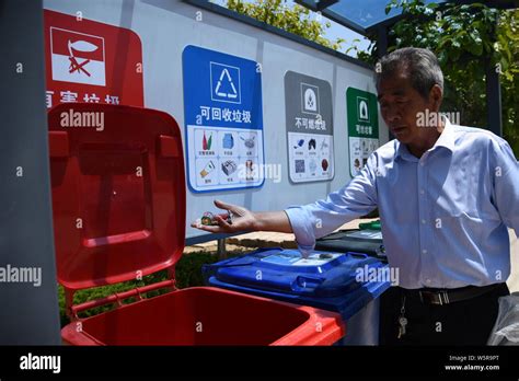 A Chinese Volunteer Introduces Garbage Sorting To A Villager In Dongchu Village Rongcheng City