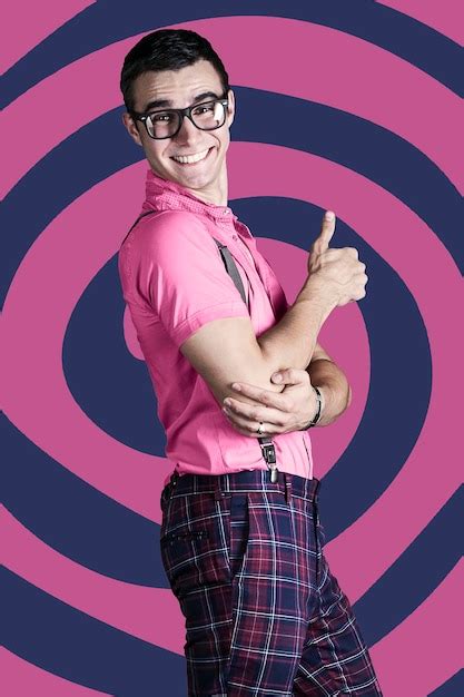 Premium Photo Portrait Of Smiling Nerd Gesturing Thumbs Up Against Colored Background