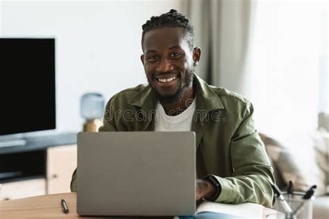 Cheerful African American Guy Programmer Sitting At Workdesk At Home