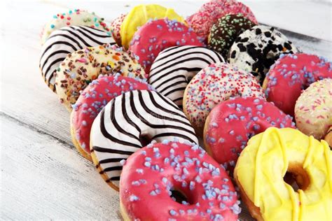 Donuts In Different Glazes With Chocolate Sprinkles And Stripes Stock