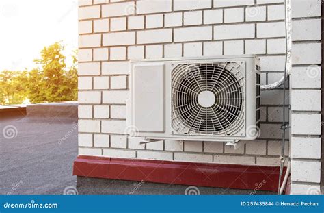 Wall Mounted Industrial Air Conditioner On A Brick Wall Of A Building Maintenance And Repair Of
