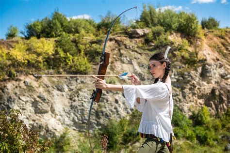 Hunter Girl Shooting Bow And Arrow In The Grassland Stock Image Image