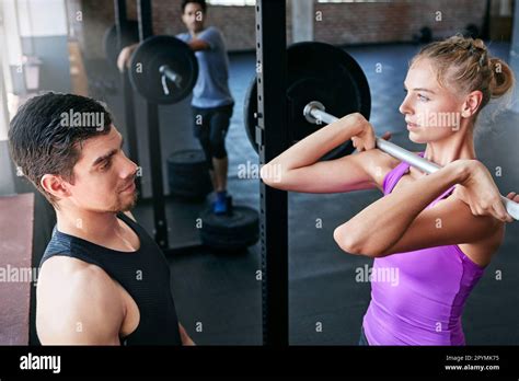 Set A Goal And Make It Happen A Young Woman Lifting Weights With Her