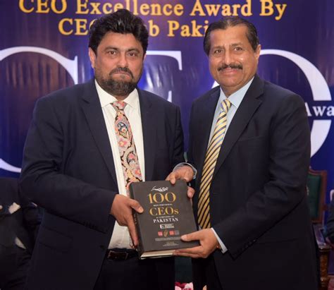 Dr Mirza Ikhtiar Baig Receiving 100 Best Performing Ceos Book From