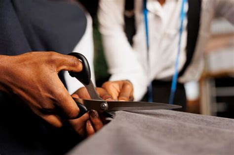 Premium Photo Close Up Of Tailor Using Scissors