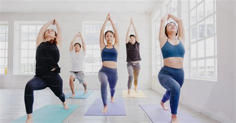 젊은 아시아 스포티 한 매력적인 사람들은 강사와 함께 요가 수업을 연습합니다 피트니스 스튜디오에서 건강한 라이프 스타일을 운동 하는 아시아 여성 그룹 스포츠 활동 체조