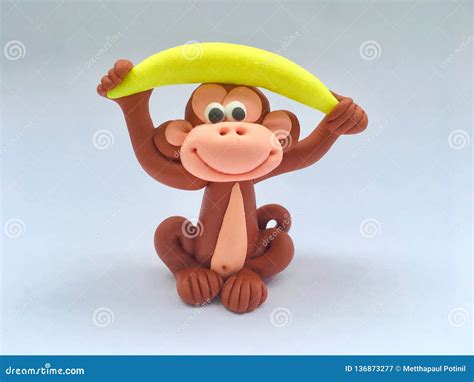 Cute Monkey Smile Doll Sitting On Wooden Box Royalty Free Stock Image
