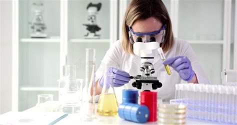 Chemist Adjusts Microscope Holding Tube With Yellow Liquid Stock Video Video Of Examination